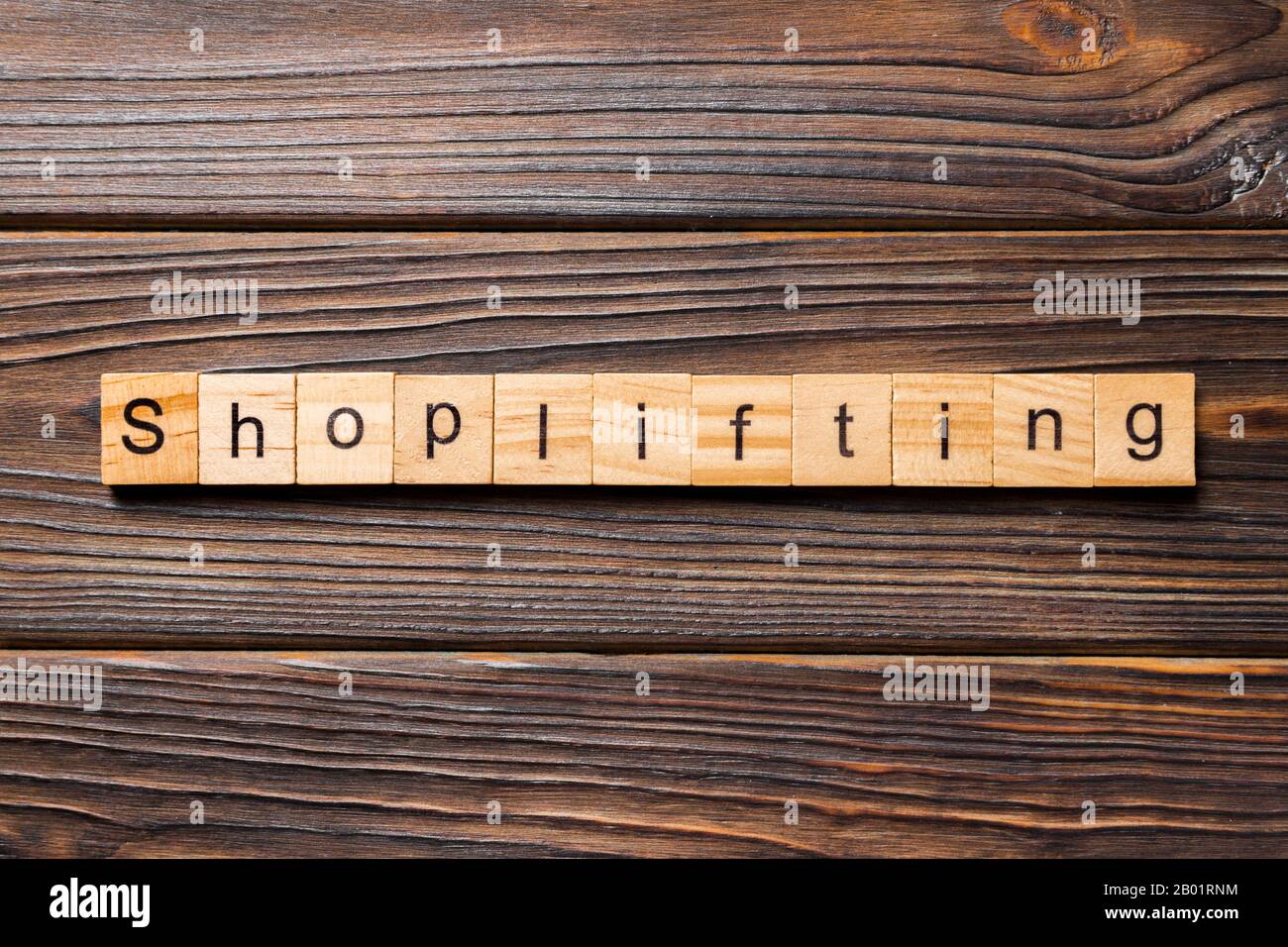 Shoplifting word written on wood block. Shoplifting text on wooden ...