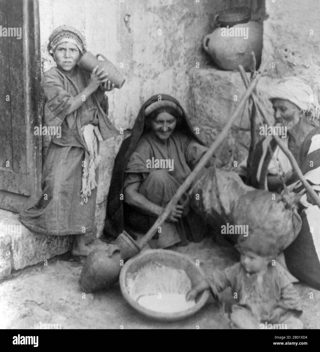 Palestine: A Palestinian family churning butter in a goatskin at ...
