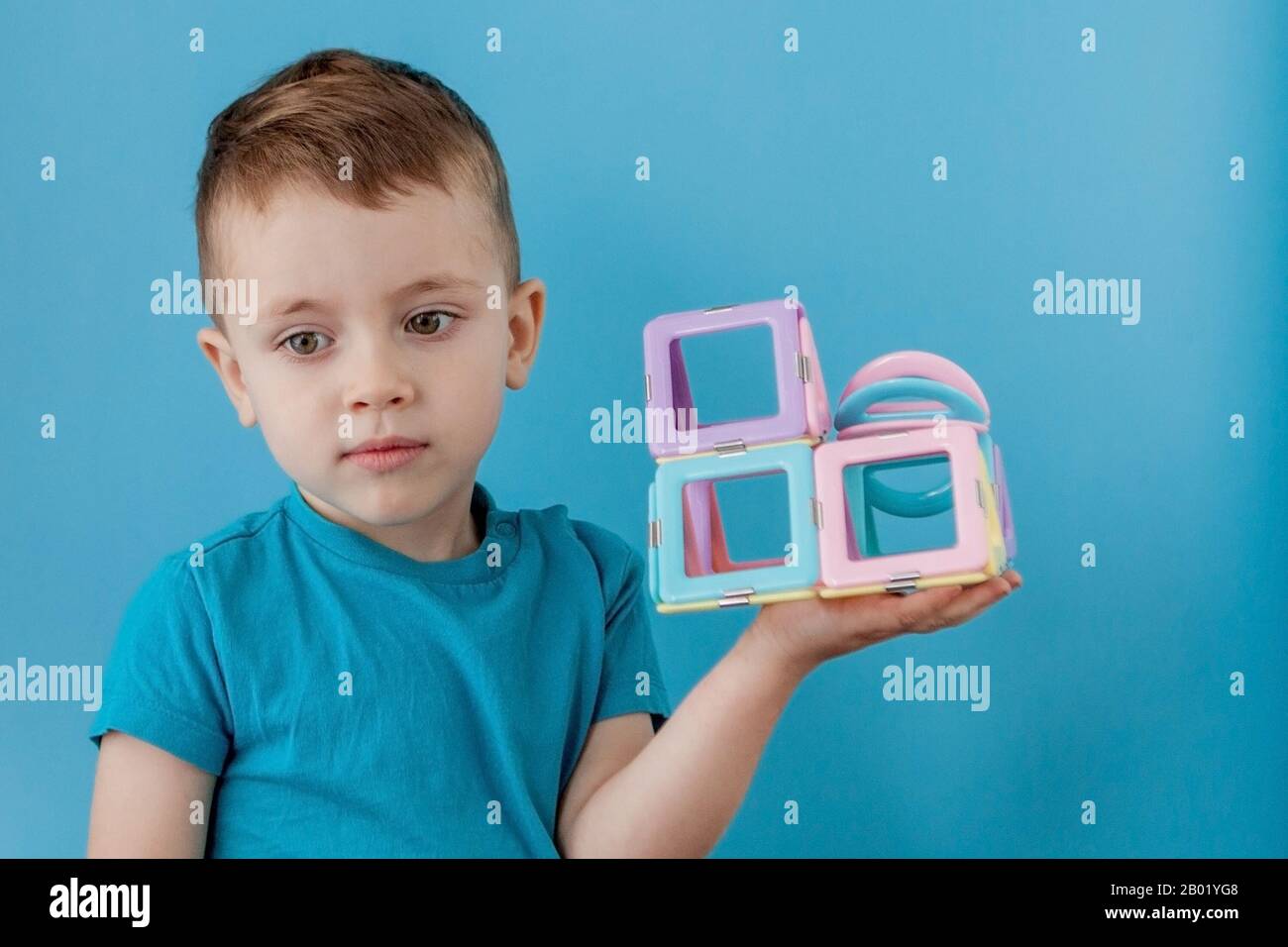 Boy looks through the shape in the color constructor with the ...