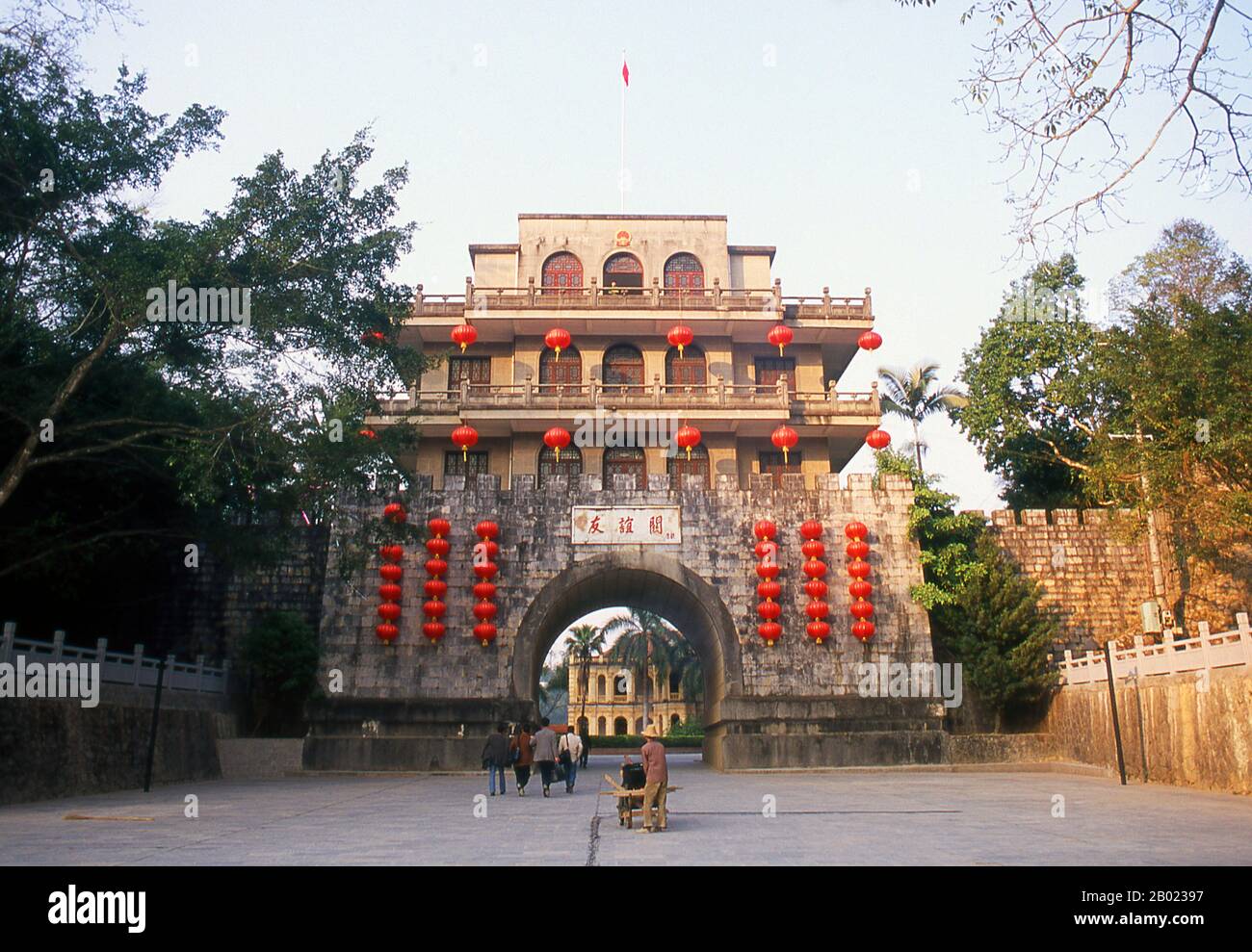 China: Ceremonial Chinese gateway with the old French Customs House in ...