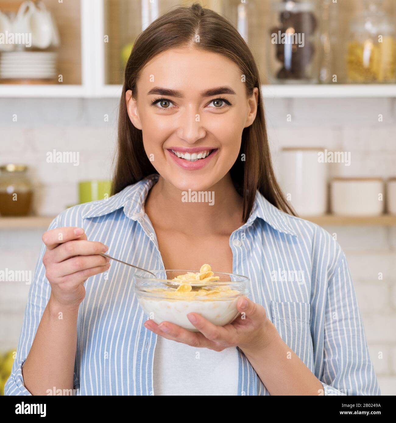 Calcium daily dose.. Happy girl eating cereals for breakfast Stock ...