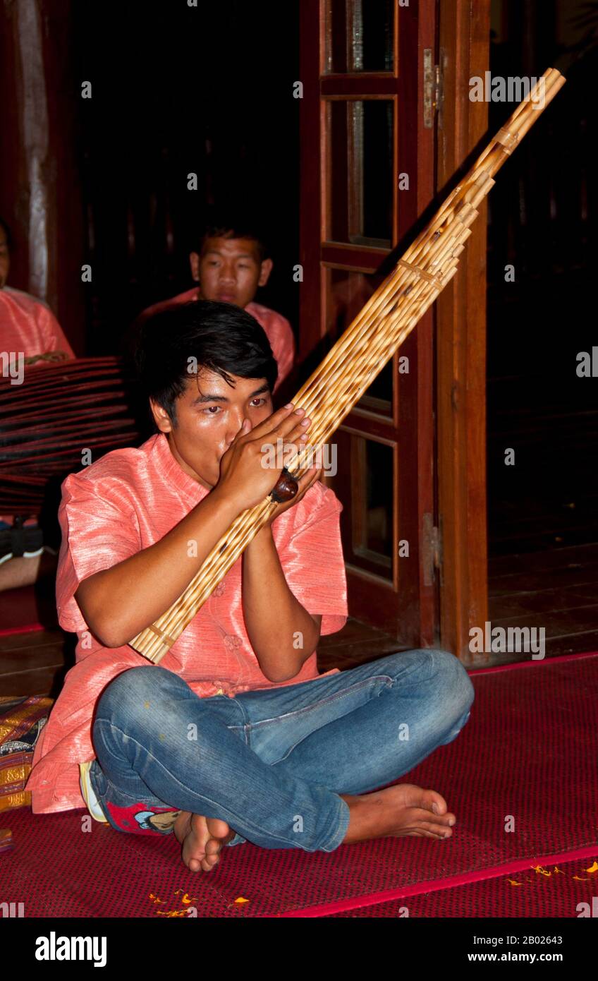 Laos: A man playing a khene (kaen), a traditional Lao instrument made ...
