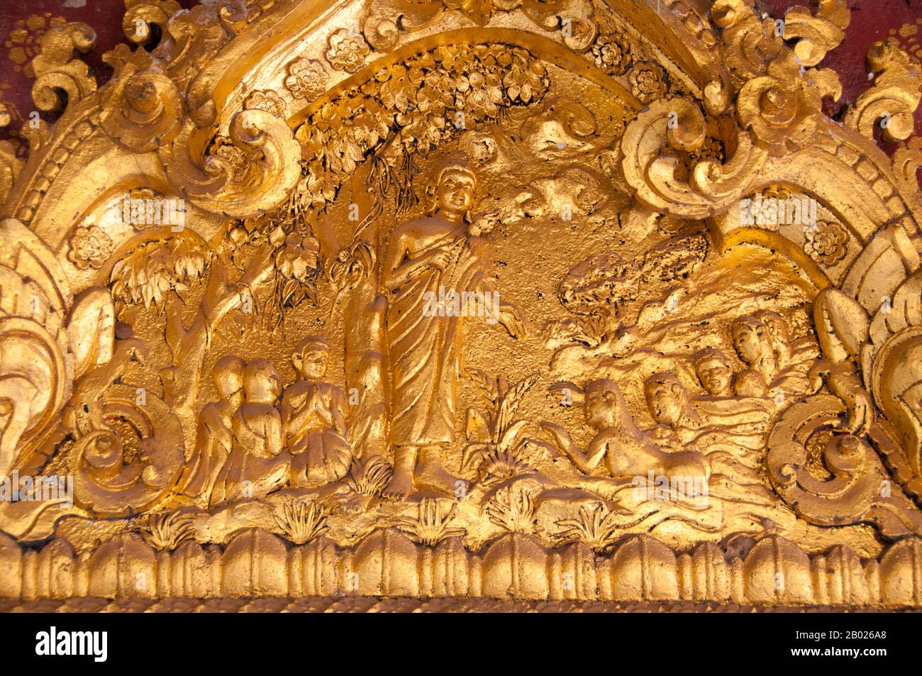 Laos: Buddha preaching, detail over the door of the sim (ordination ...
