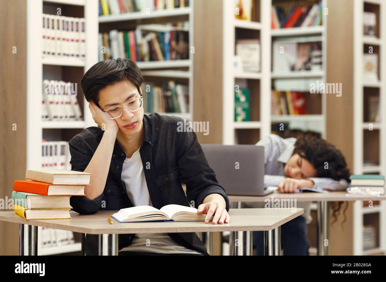Tired students napping in the university library Stock Photo - Alamy