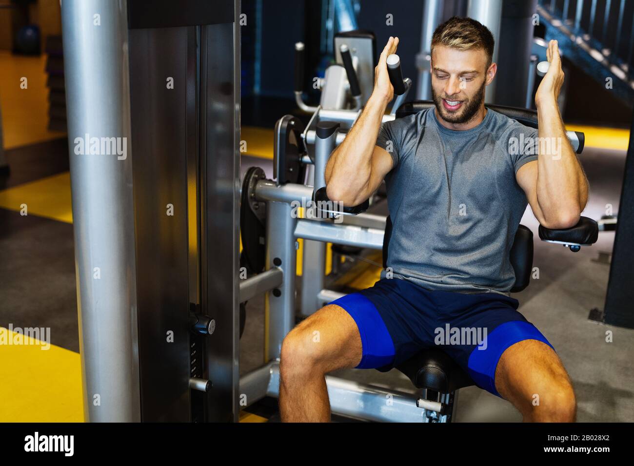 Man with weight training equipment exercising in sport gym club Stock ...