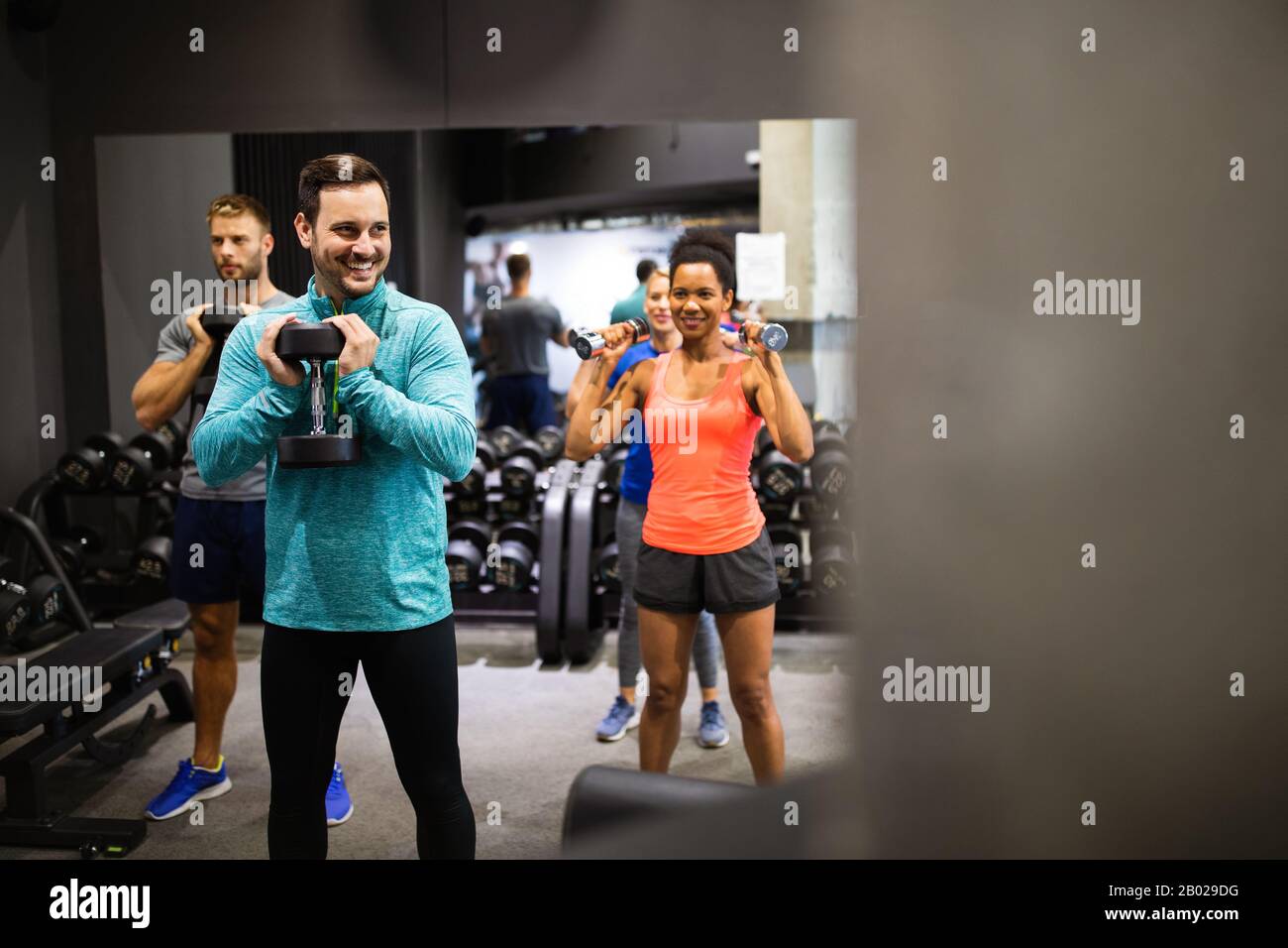 Group of fit people in gym training. Multiracial group of friends ...