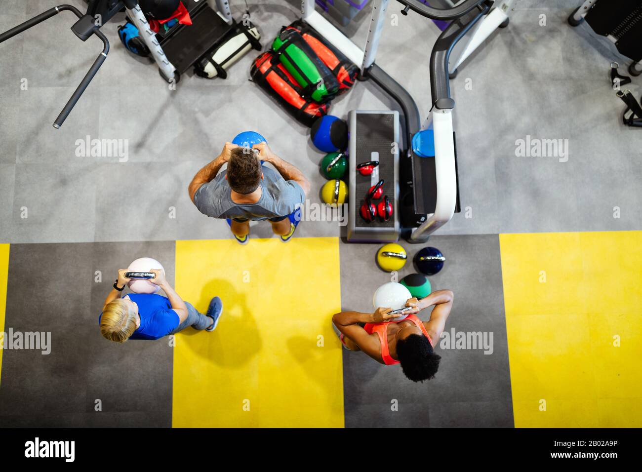 Group of fit people in gym training. Multiracial group of friends ...