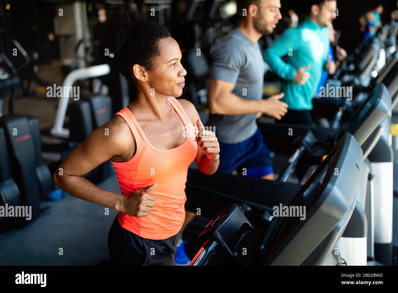Group of young people running on treadmills in sport gym Stock Photo ...