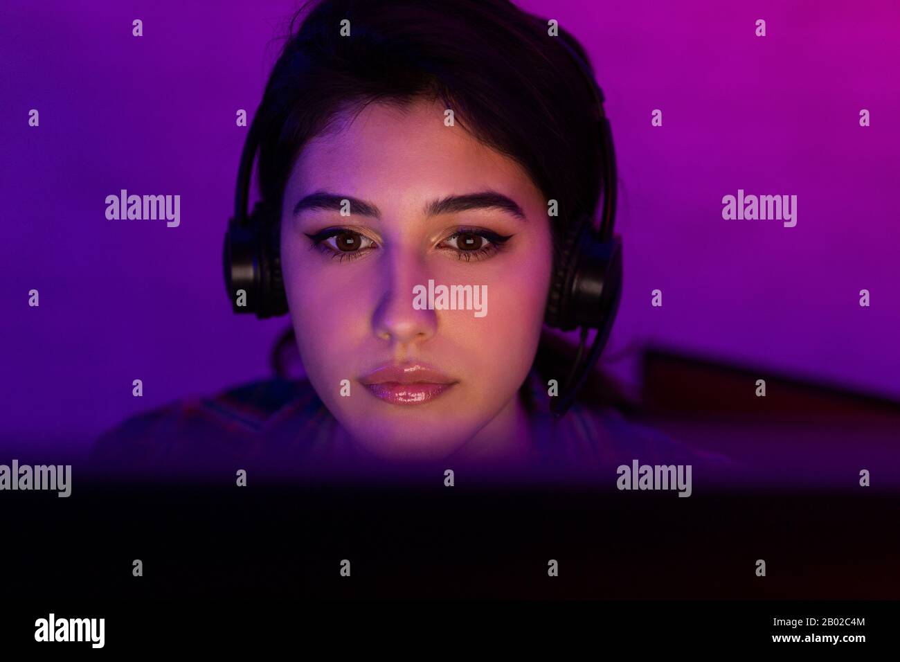 Millennial Girl Gamer Playing Videogame On PC Indoor At Night Stock ...