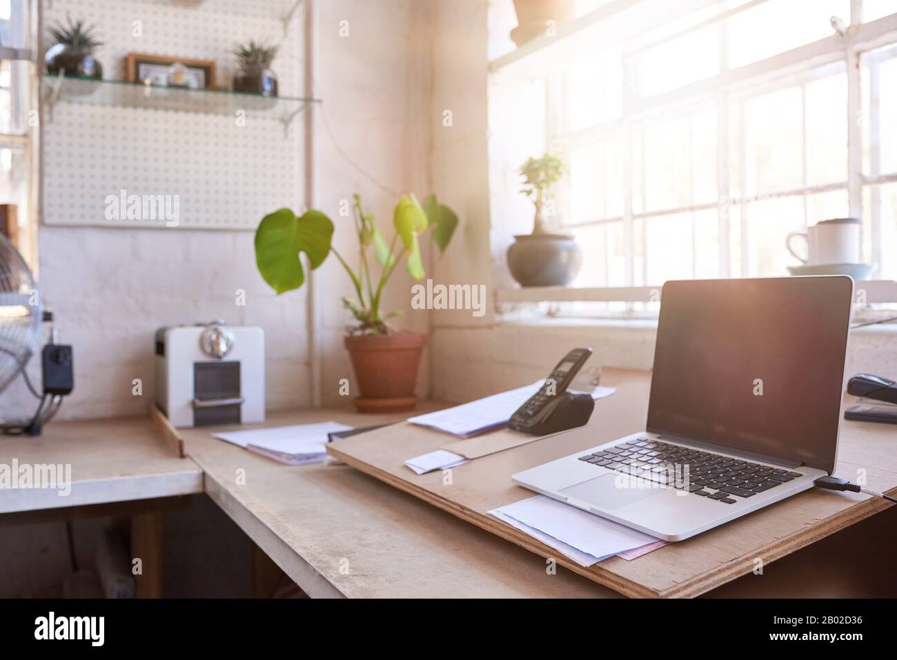 Laptop sitting on a workstation inside of a framing shop Stock Photo ...