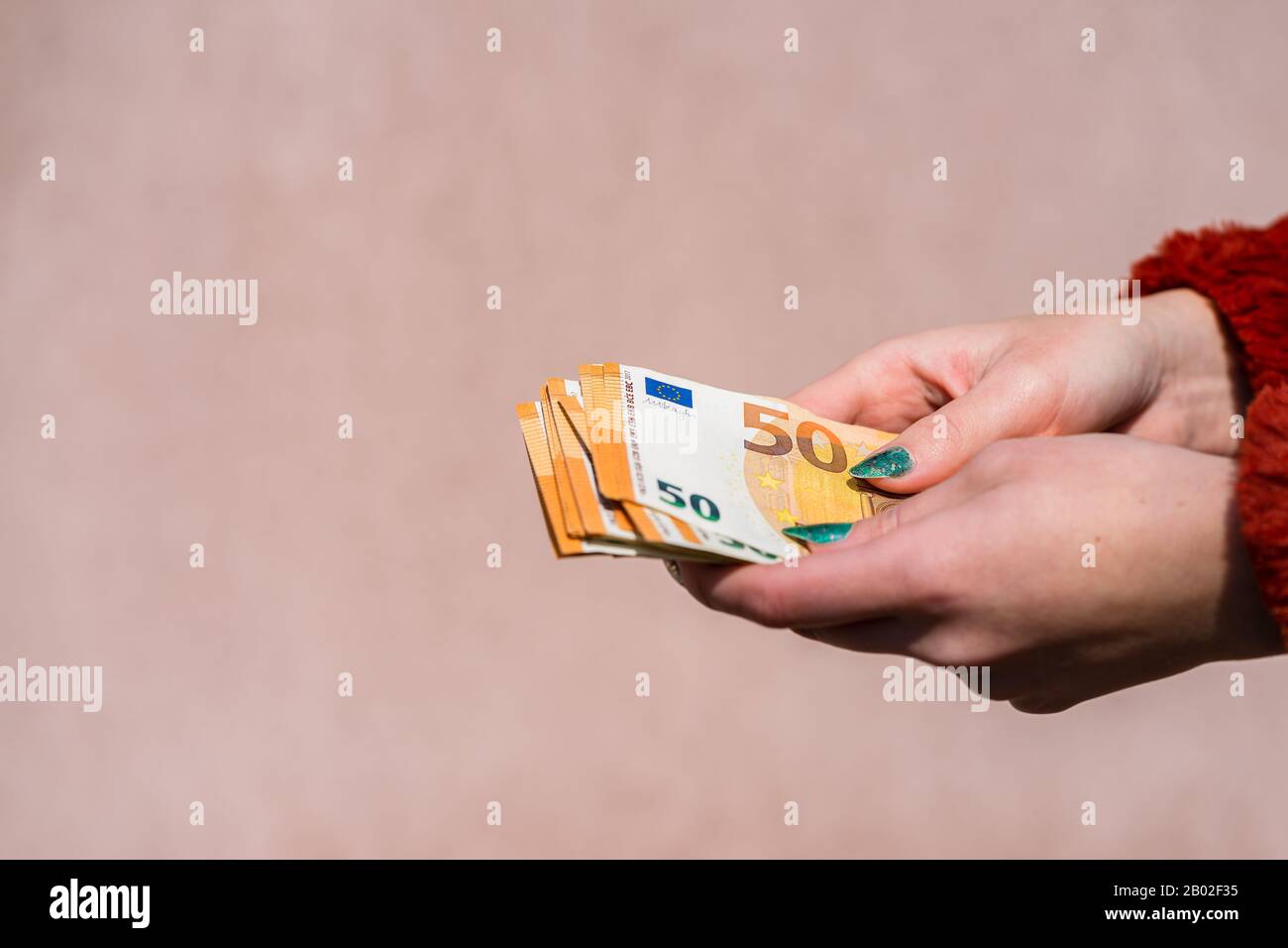 Hand holding showing euro money and giving or receiving money like tips ...