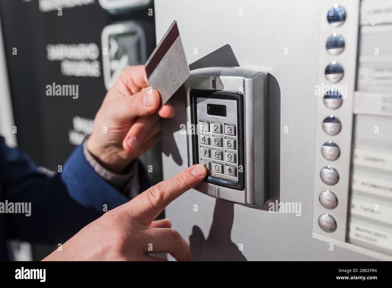 Man scanning security key card on electric lock and entering security ...