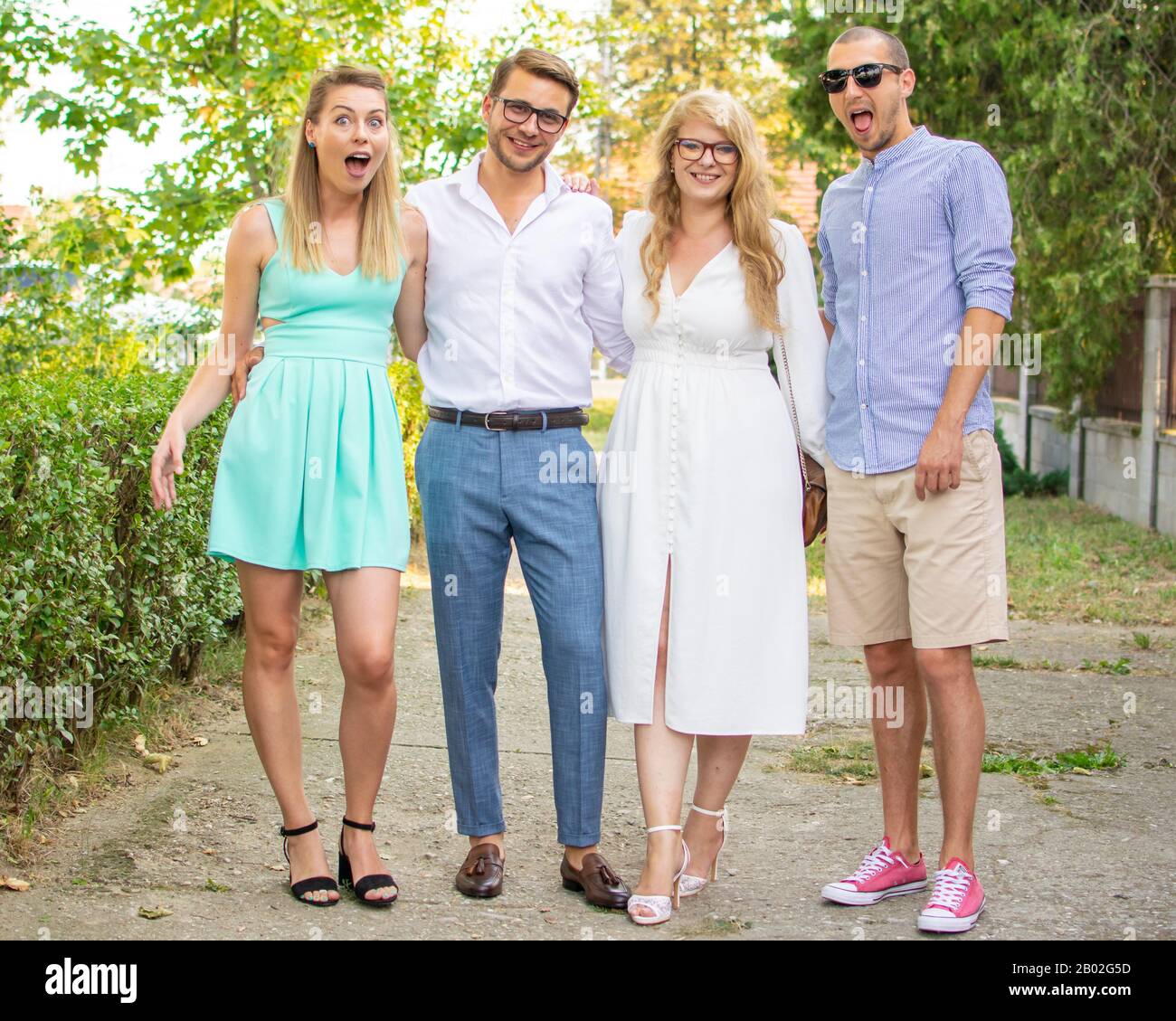 Group of four friends laughing out loud outdoor Stock Photo - Alamy