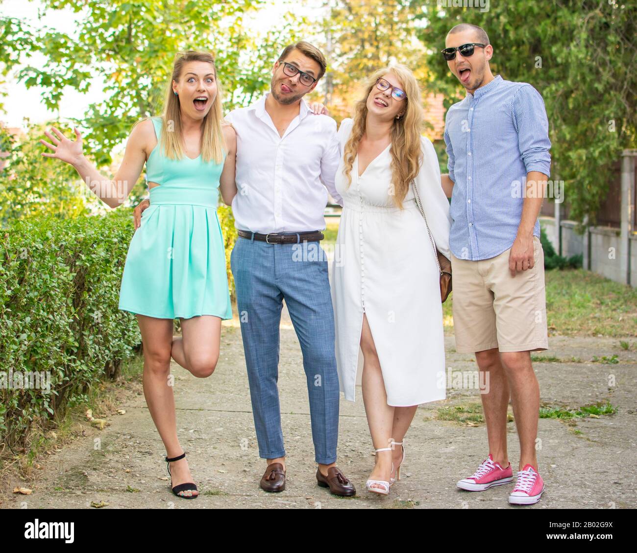 Group of four friends laughing out loud outdoor Stock Photo - Alamy