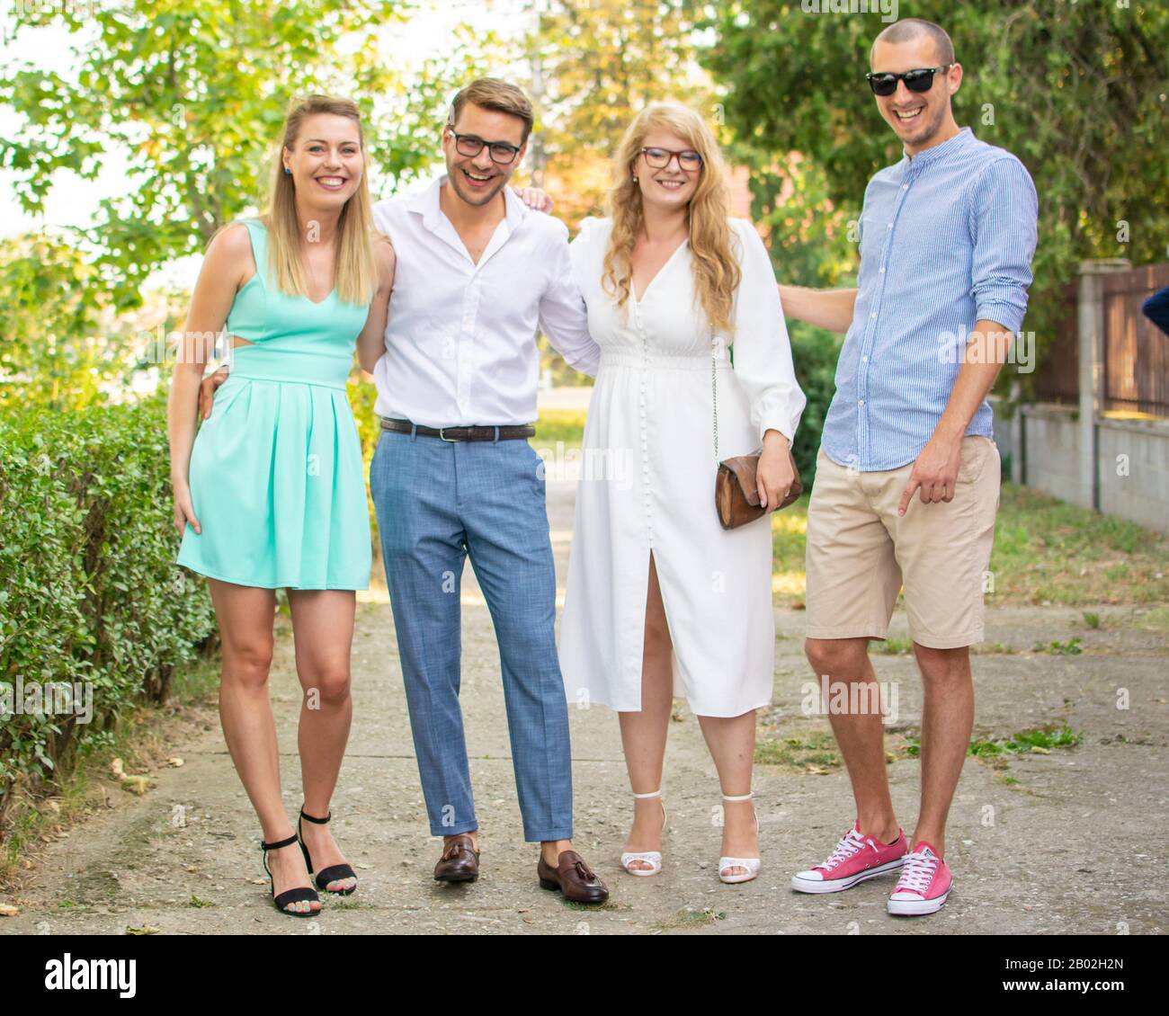 Group of four friends laughing out loud outdoor Stock Photo - Alamy