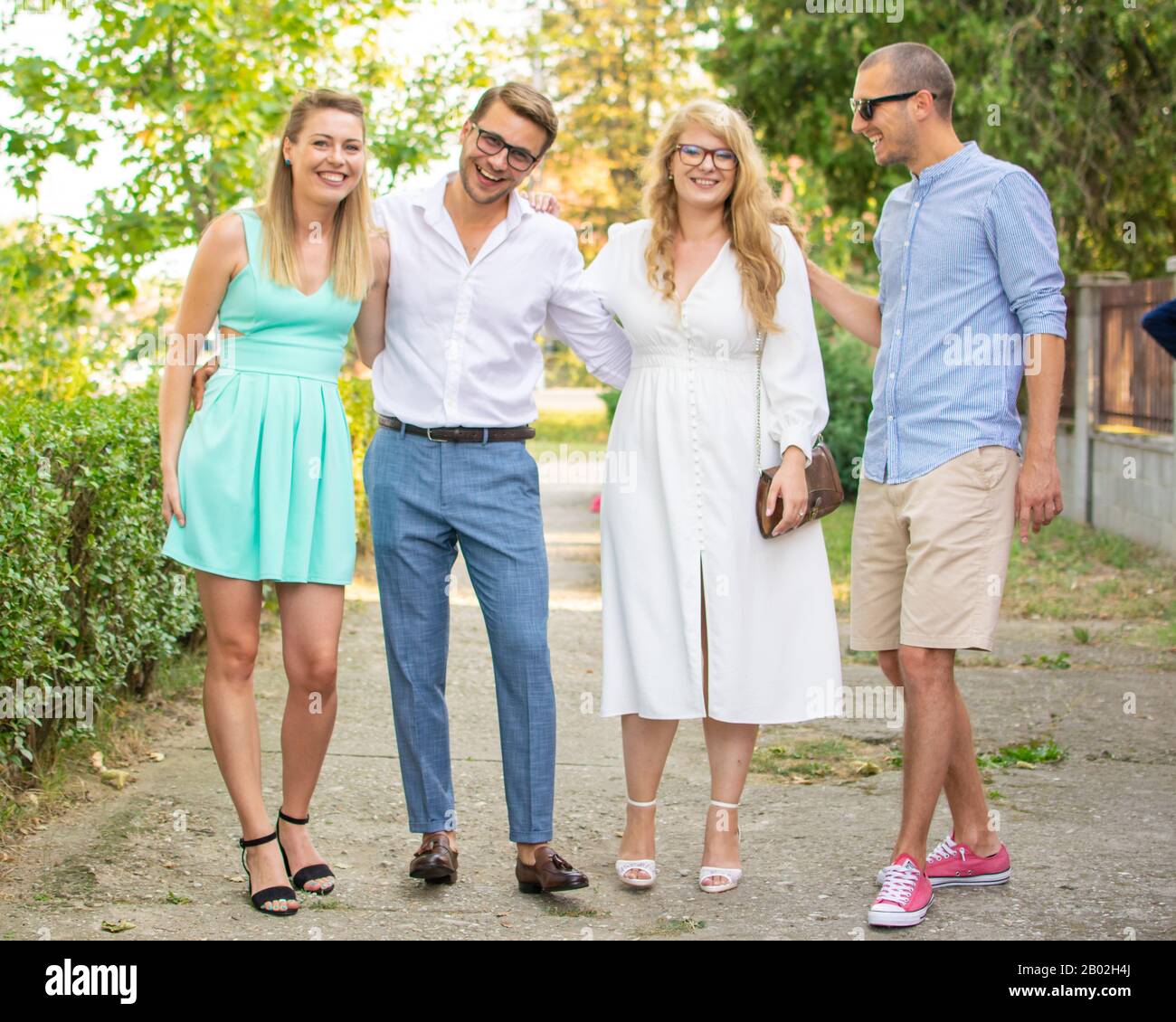 Group of four friends laughing out loud outdoor Stock Photo - Alamy