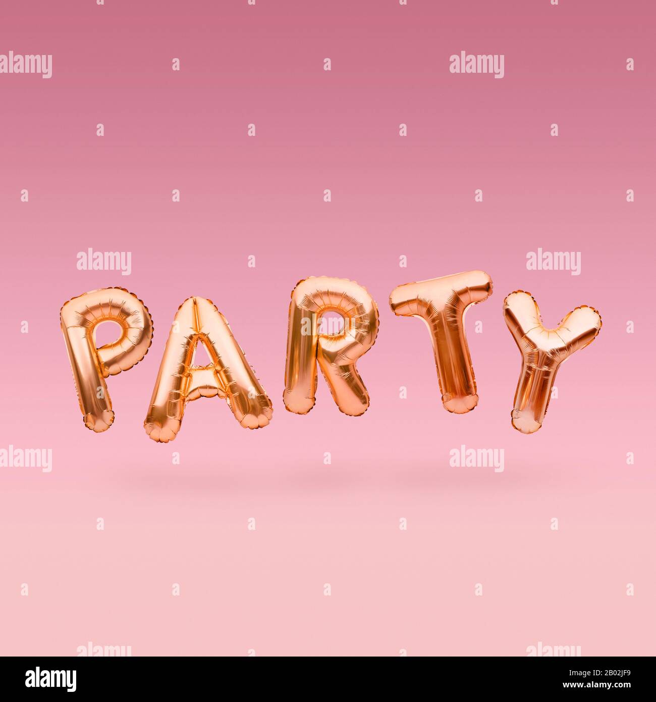 Golden word PARTY made of inflatable balloons floating on pink ...