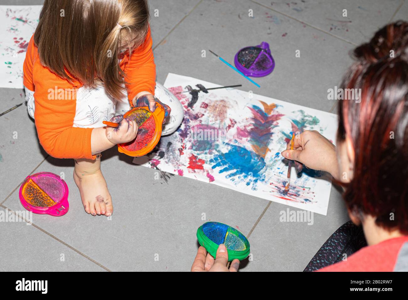 Mother and her daughter enjoying drawing, painting process, close up ...