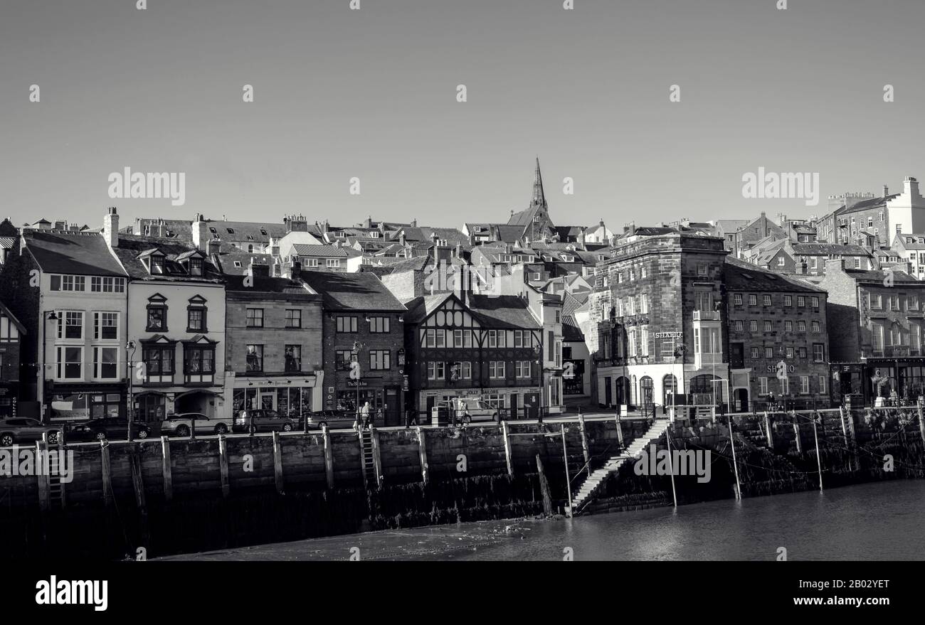 A panorama of the town on the waterfront at Whitby. Buildings line the ...