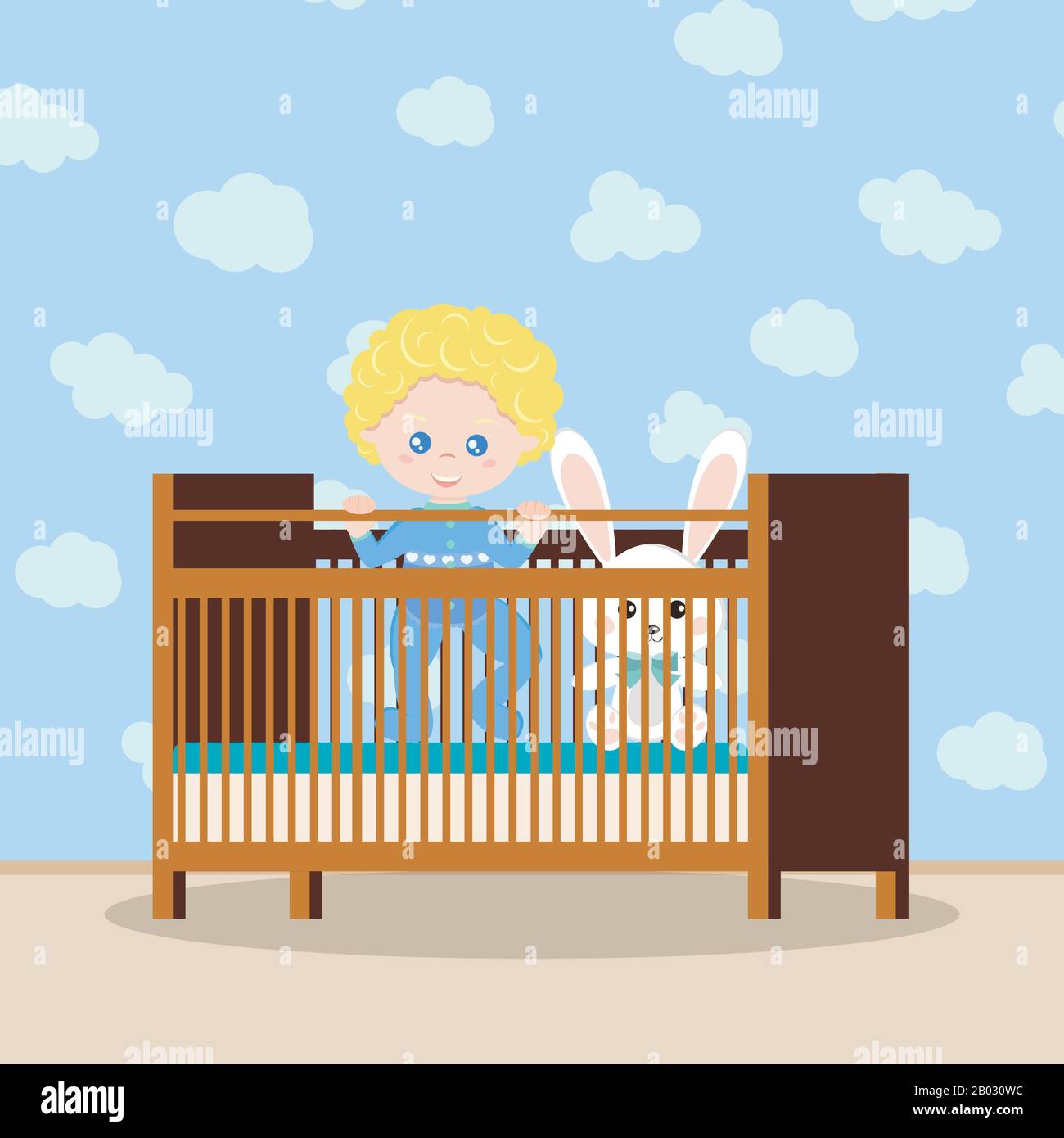 Happy baby boy in blue sleepwear standing in the wooden crib with soft ...