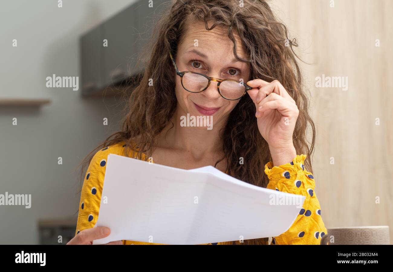 a young woman looking at received mail at home Stock Photo - Alamy