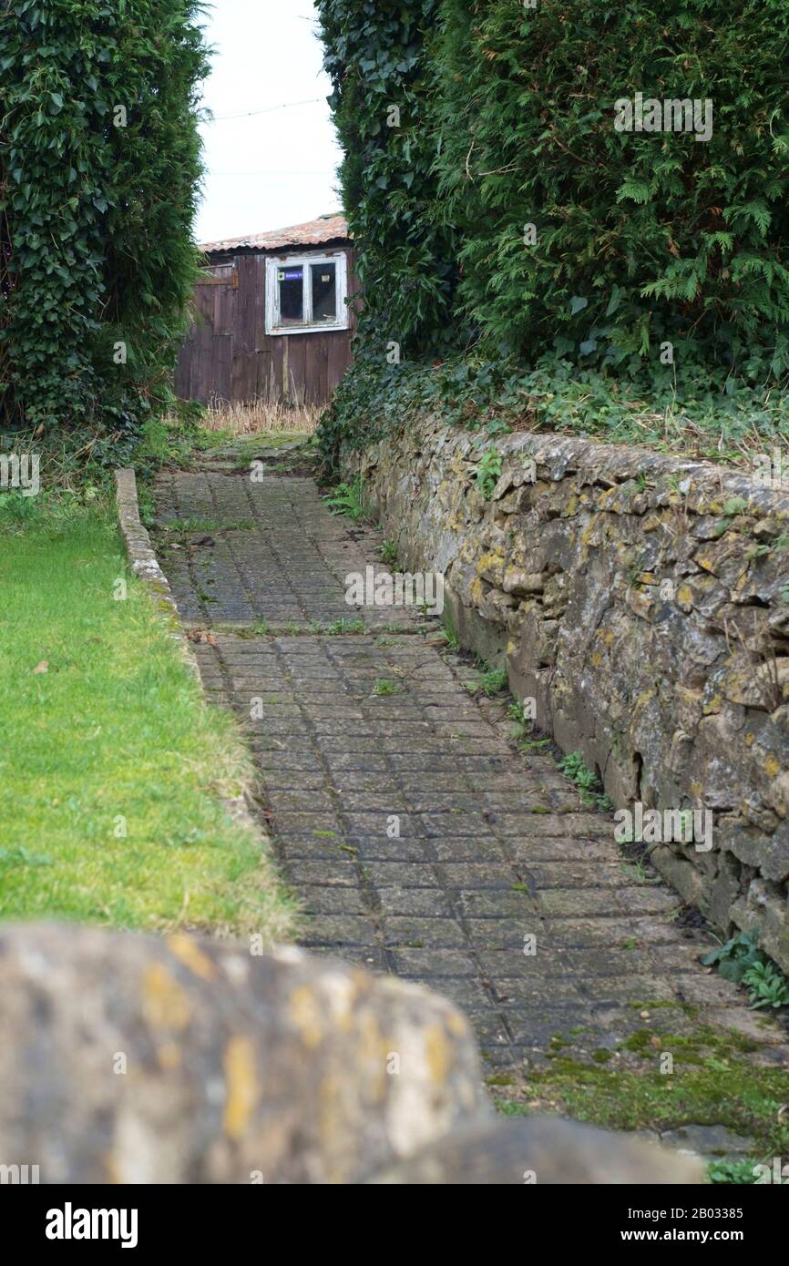 Path leading up to an old shed in the Wiltshire village of Lacock Stock ...