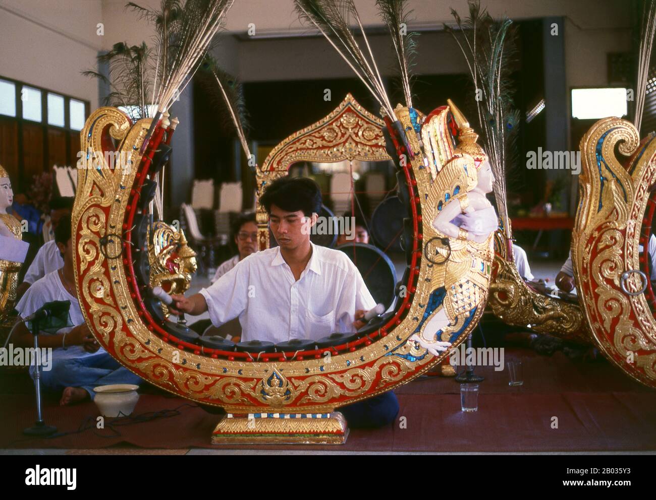 Thailand: A young man plays the khong mon, a gong-circle instrument, in ...