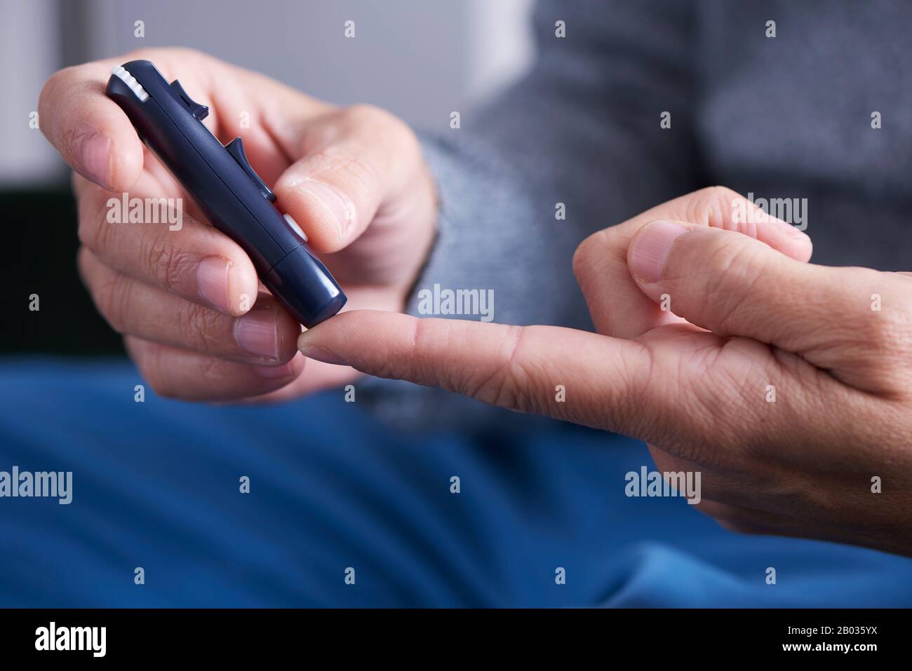closeup of a caucasian man about to measure his blood glucose level in ...
