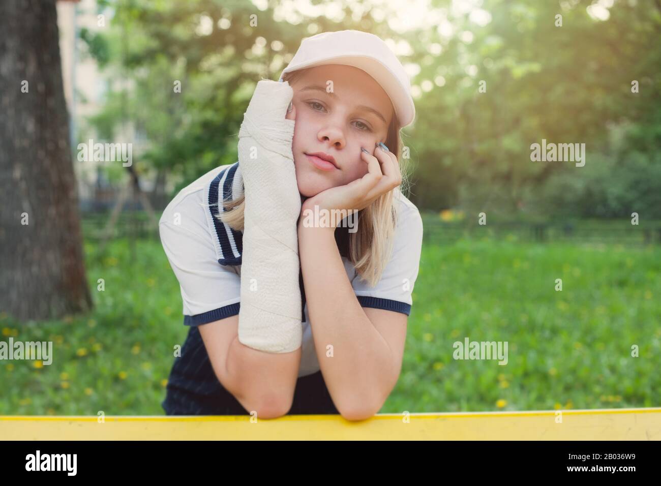 Boring teenage girl young sportswoman with arm injury outdoors Stock ...