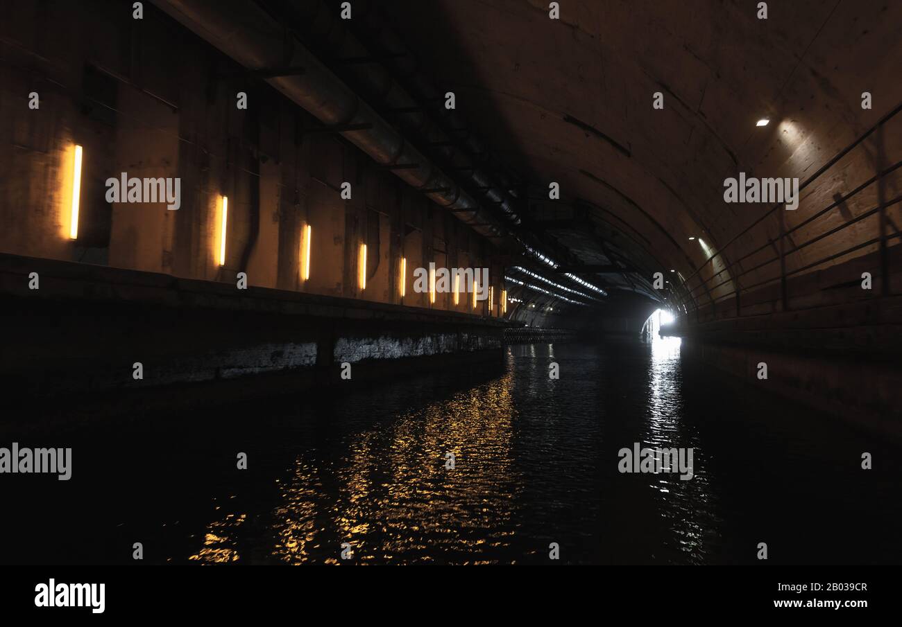 Illuminated concrete tunnel perspective, part of abandoned underground ...