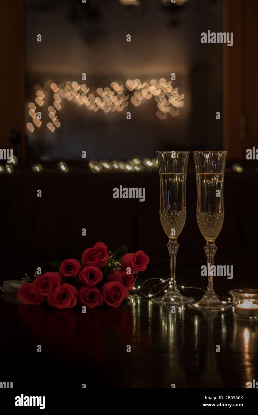 Champagne and roses on dark table for romantic dinner date night heart ...