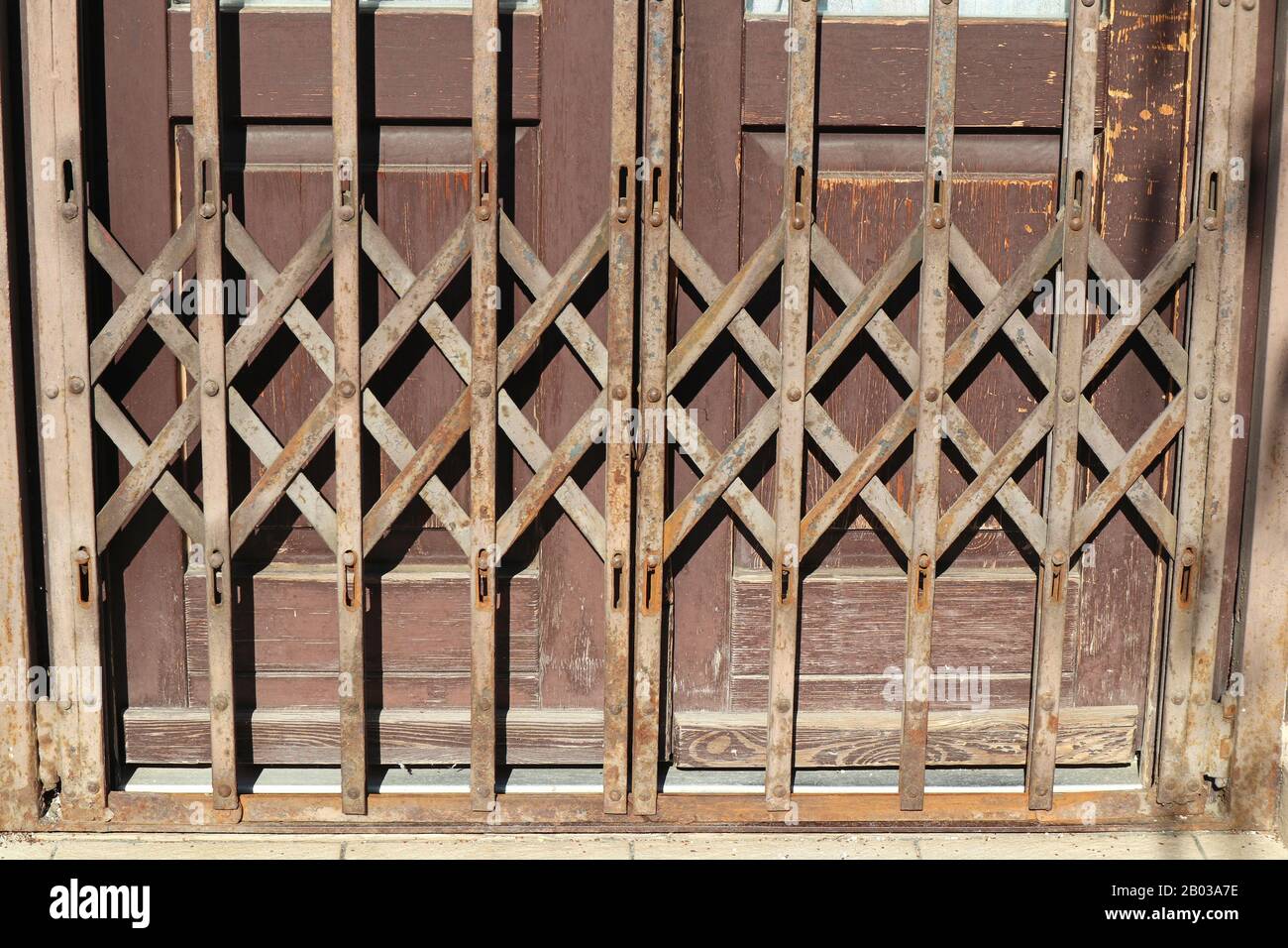 Metal security system in front of a shop door Stock Photo - Alamy