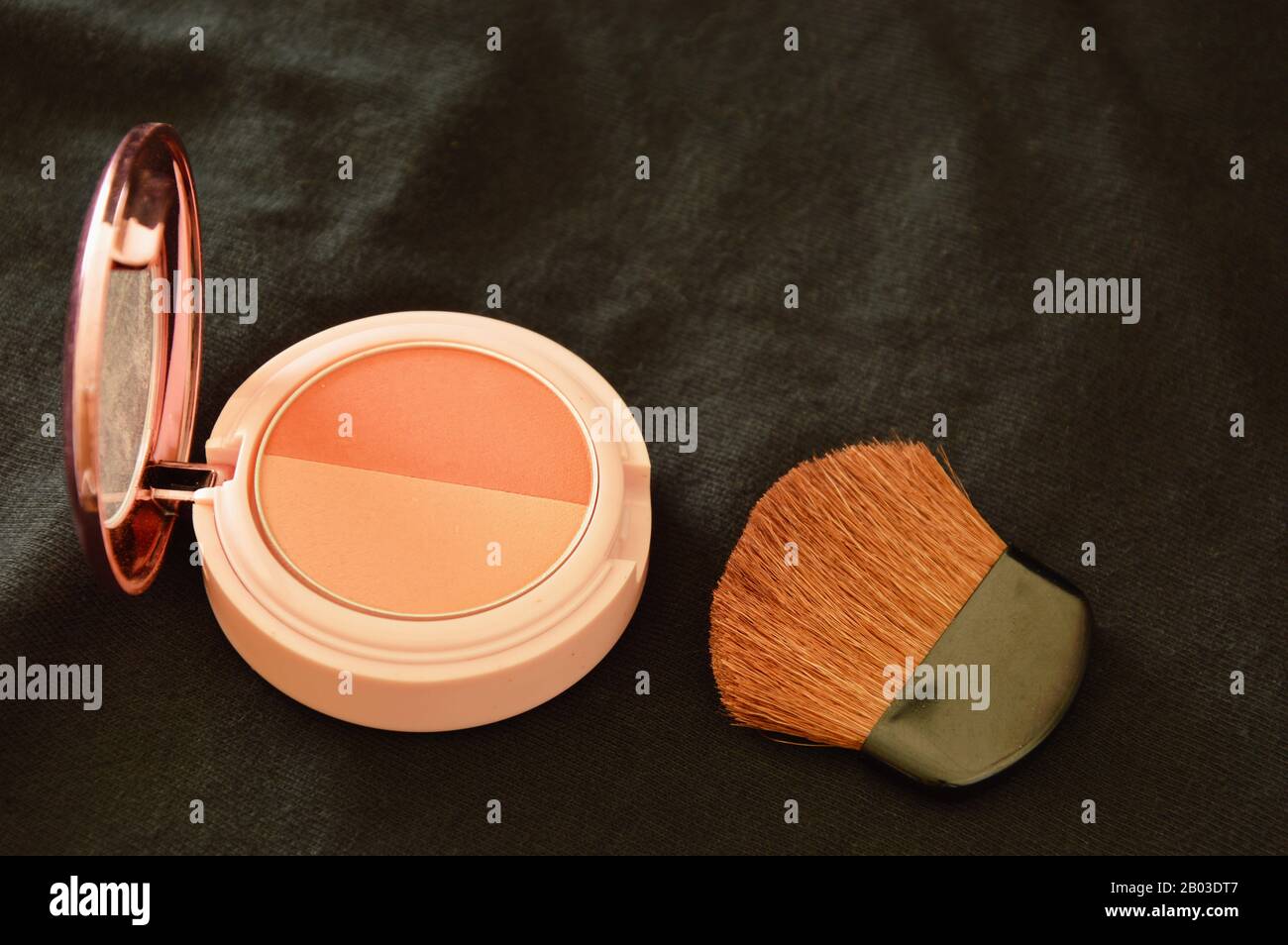 blusher powder cartridges and brush on black fabric background Stock ...