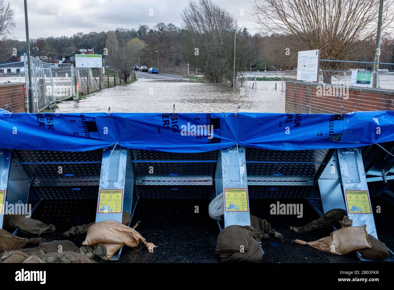 flood barrier holding back river water with bust banks Stock Photo - Alamy