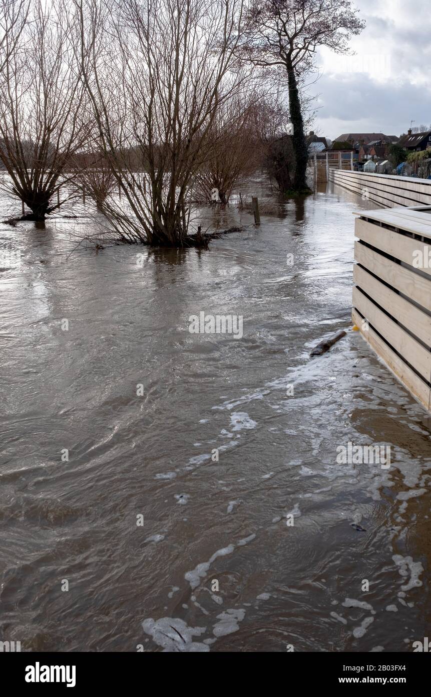 A river bursts it banks in the UK causing flooding Stock Photo - Alamy
