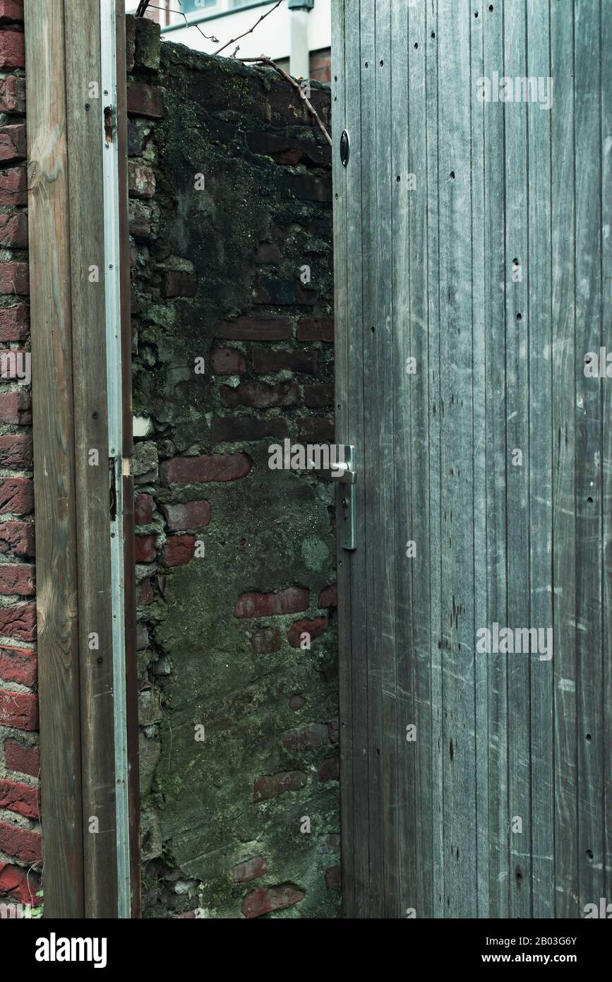 Weathered wooden garden door ajar Stock Photo - Alamy