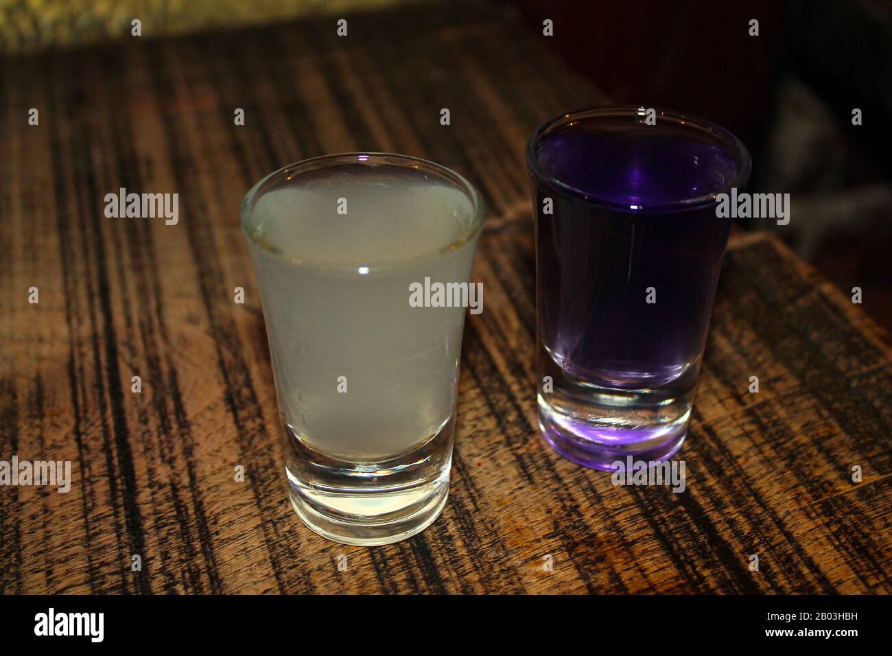 Yellow and violet shots of vodka Stock Photo - Alamy