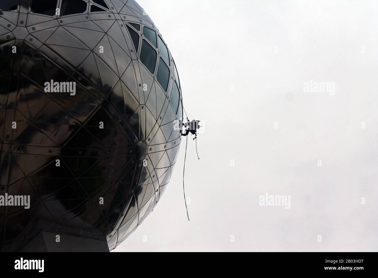 The climbing man on the sphere Stock Photo - Alamy