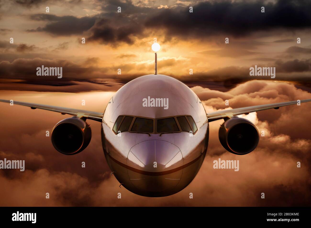 Airplane flying above the clouds during colorful sunset or sunrise ...