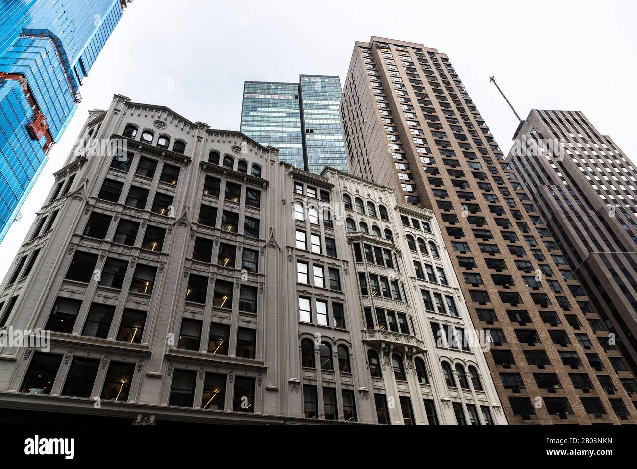 Low angle shot of modern skyscrapers and old classic buildings in ...