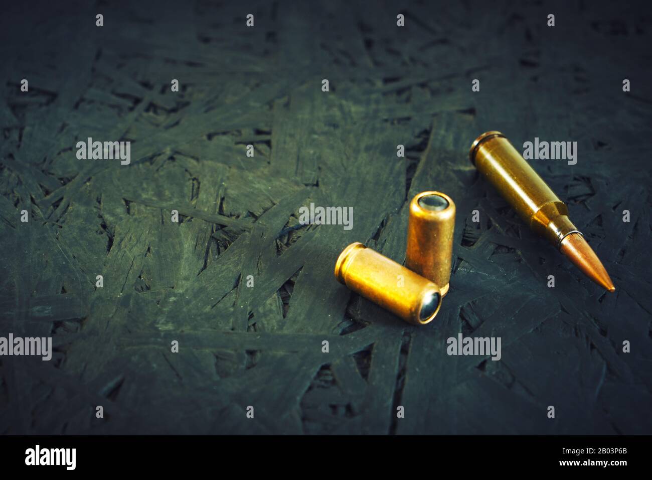 Bullets from a machine gun and a pistol on a dark background Stock ...