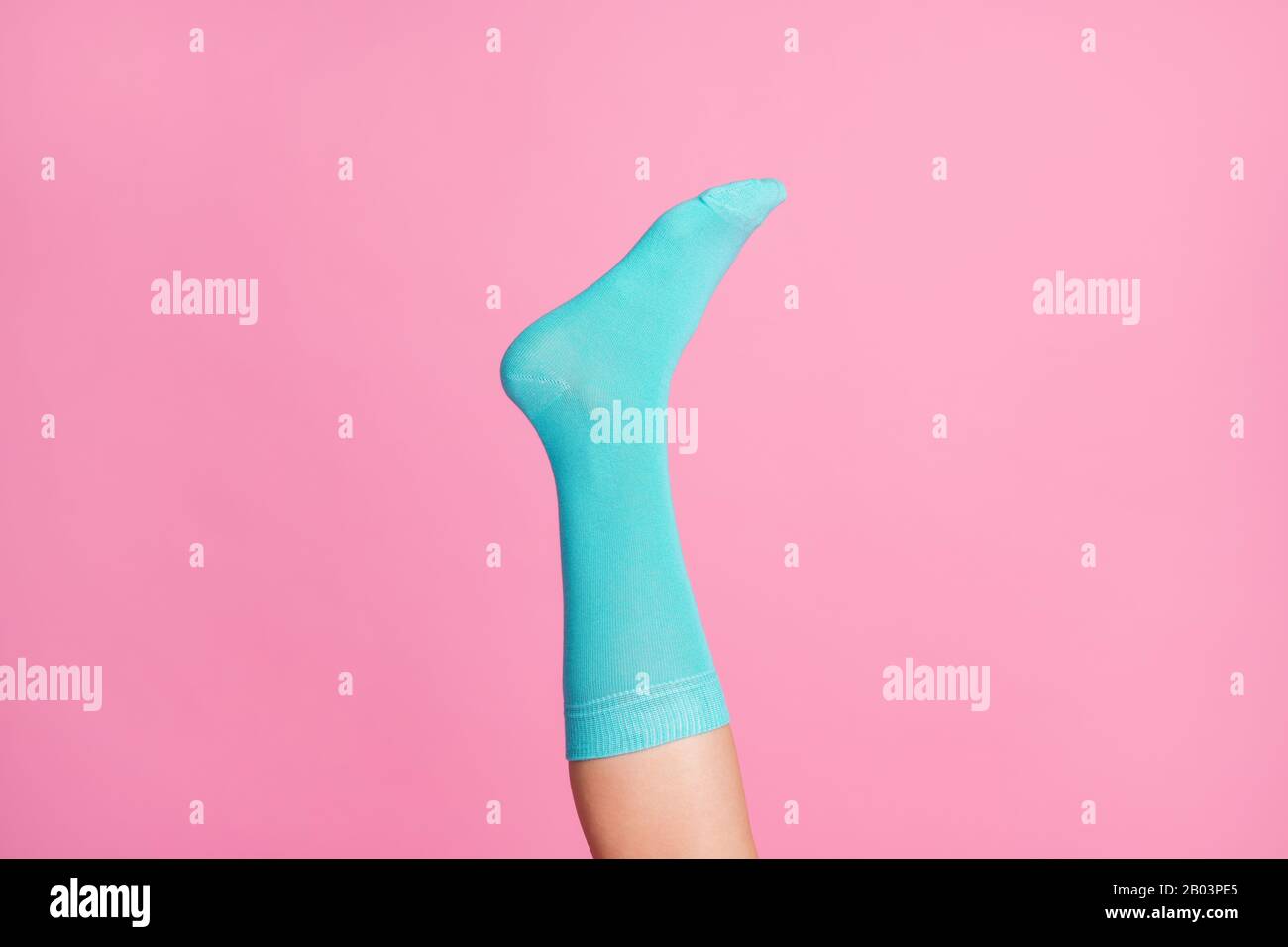 Cropped close-up view of one nice single leg wearing blue soft cotton ...