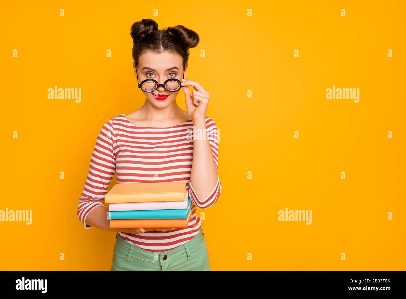 Photo of student nerd lady hold many books look tricky taking off funny ...