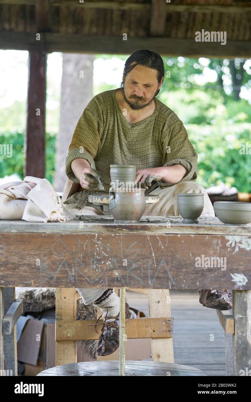 Traditional potter using ancient Dacian method on a foot-powered clay ...