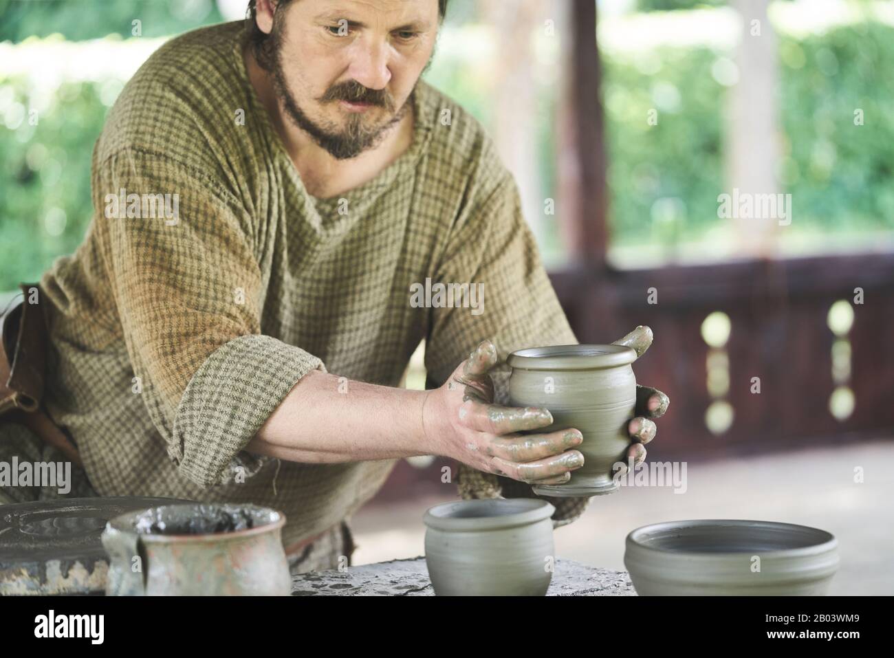 Traditional potter using ancient Dacian method on a foot-powered clay ...