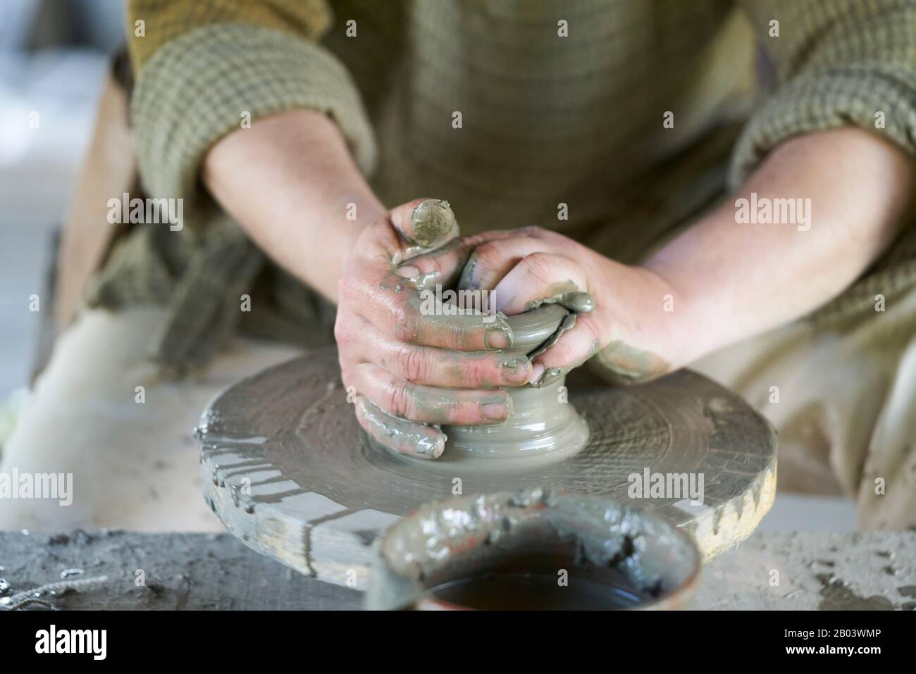 Traditional potter using ancient Dacian method on a foot-powered clay ...