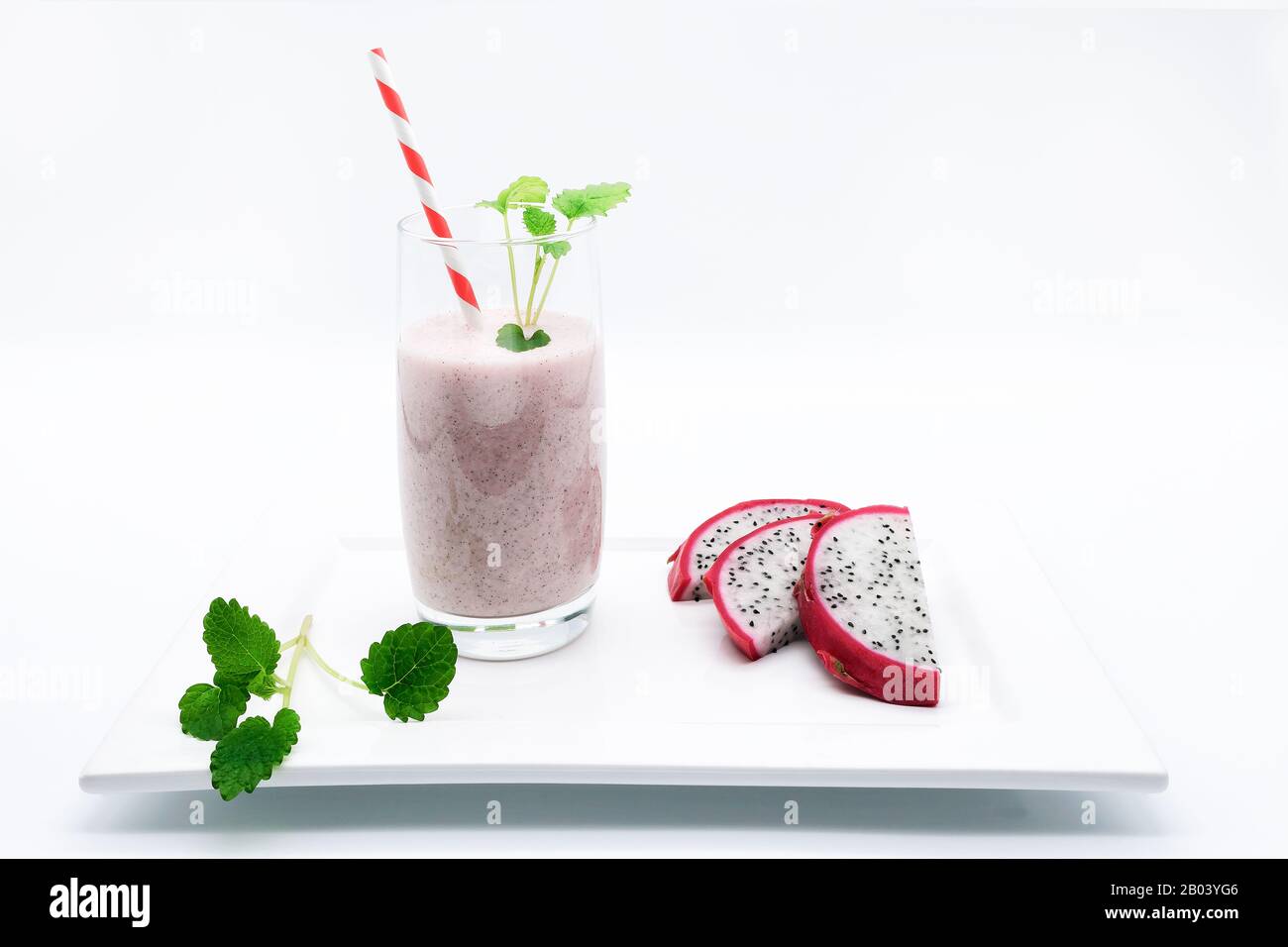 a dragon fruit / kite fruit smoothie on a white porcelain plate with ...