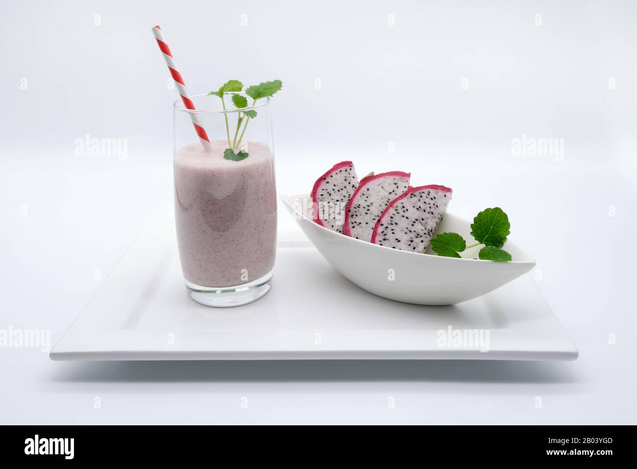 a dragon fruit / kite fruit smoothie on a white porcelain plate with ...