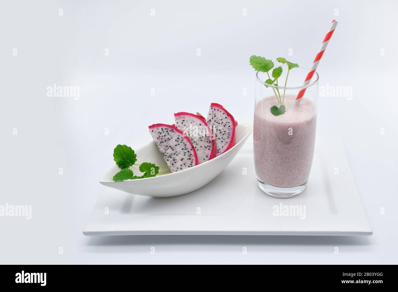 a dragon fruit / kite fruit smoothie on a white porcelain plate with ...