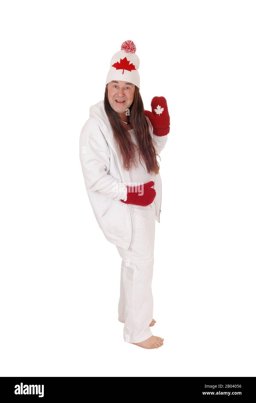 A happy indigenous man dressed in white with a hat and mittens with the ...